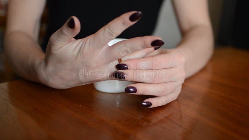 Women in Cafe with a Cup of Coffee Puts a Wedding Ring on a Finger ...