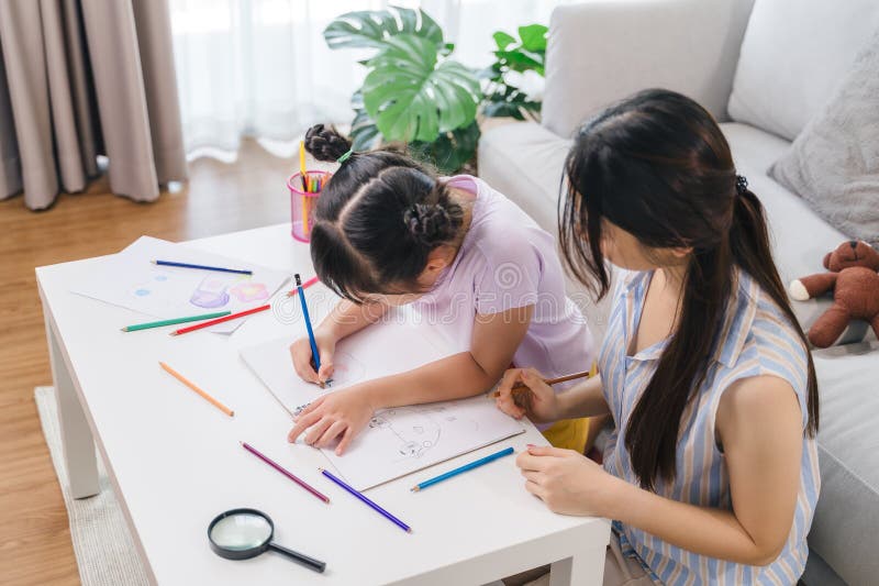 A Woman and a Child are Drawing on a Table Stock Photo - Image of ...