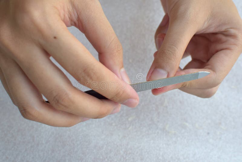 Women Clean Their Fingernails with a Nail File. Stock Photo - Image of ...