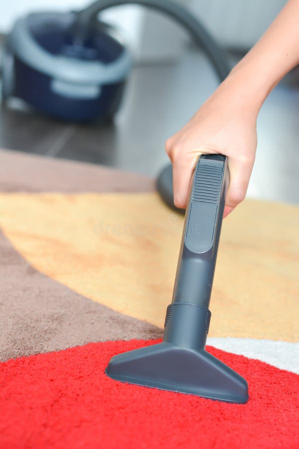 Women Cleaning a Red Carpet with a Black Vacuum Cleaner Stock Image ...