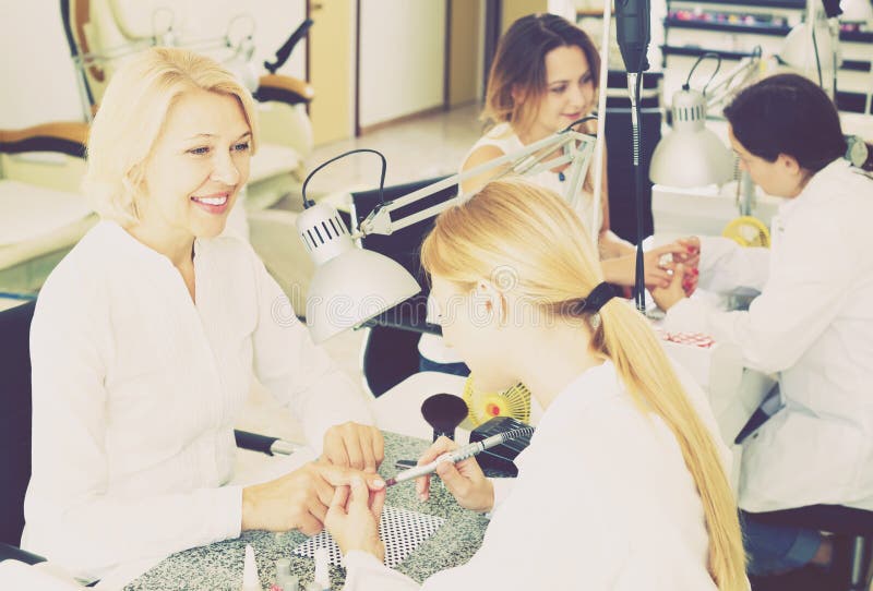 Two Women Clients Having Manicure Done In Nail Salon Stock Image ...