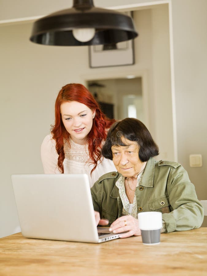 Two women and a computer stock photo. Image of computer - 9874684