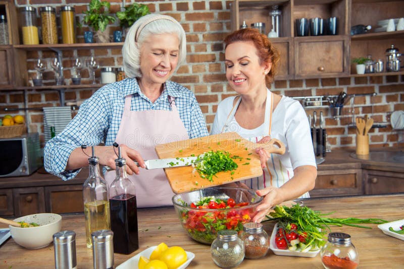 Women cooking together stock image. Image of generations - 83655465