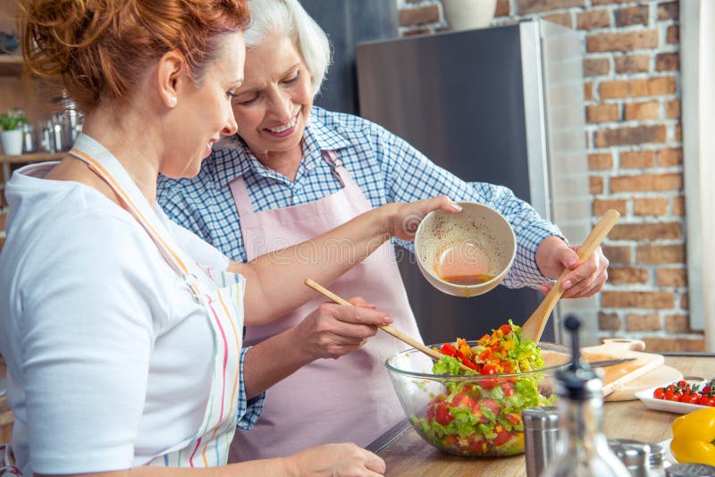 Women cooking together stock photo. Image of mother, casual - 83655716
