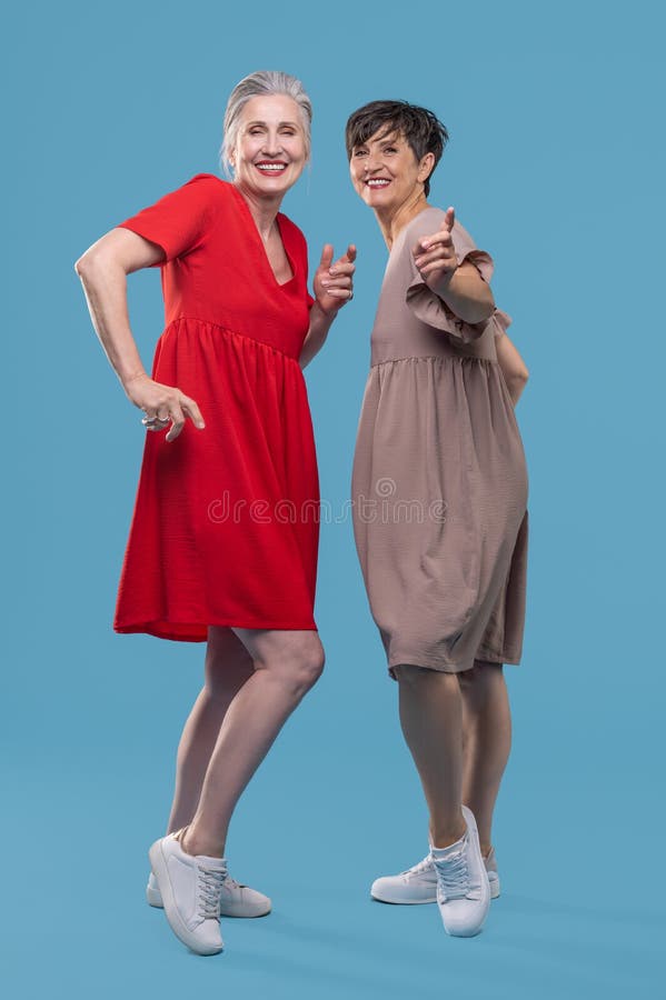 Women in Cute Dresses Having Fun and Looking Happy Stock Photo - Image ...