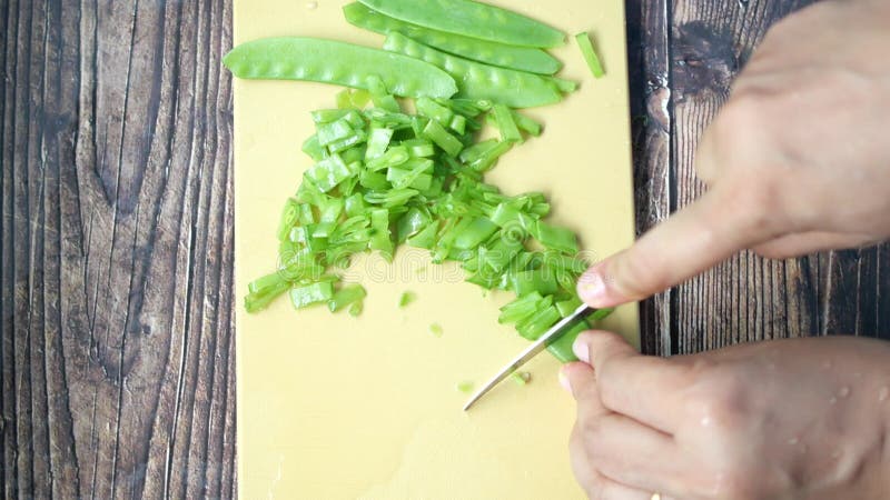 Women Cutting Holland Beans on the Cutting Board Stock Footage - Video ...