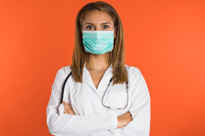 Women Doctor with Face Mask Smiles in Front of the Camera. Stock Image ...
