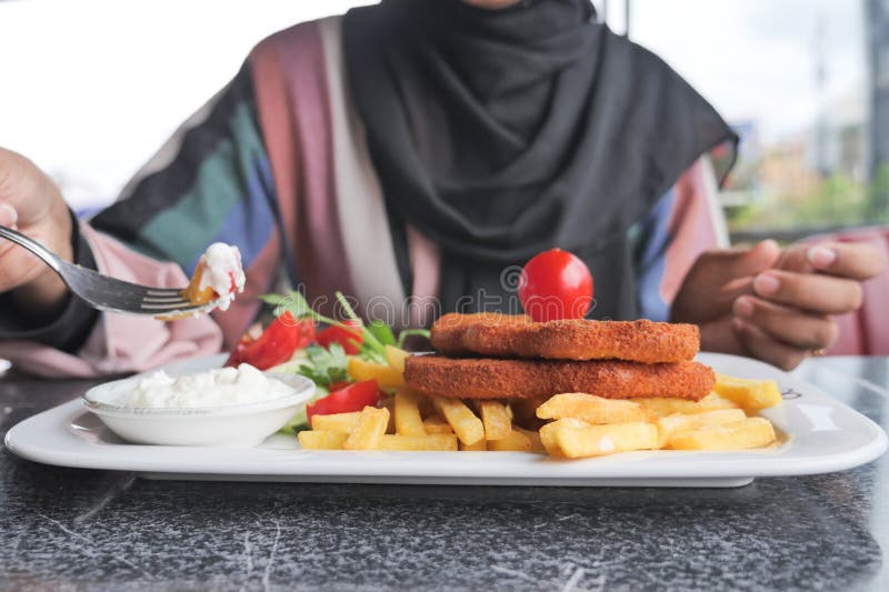 Women Eating Chicken Schnitzel Served with Potato Chips Stock Image ...