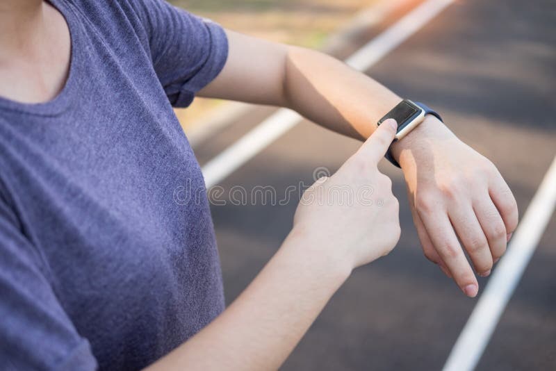 Women Exercise in the Morning Using Looking on Her Smart Watches Active ...
