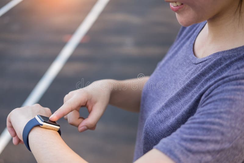 Women Exercise in the Morning Using Looking on Her Smart Watches Active ...