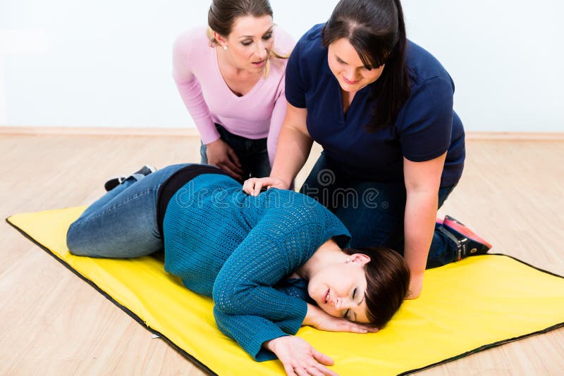 Women in First Aid Class Training To Position Injured Person Stock ...