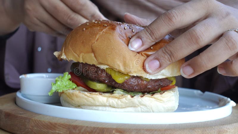 Women Hand Holding Beef Burger on Table Close Up Stock Video - Video of ...