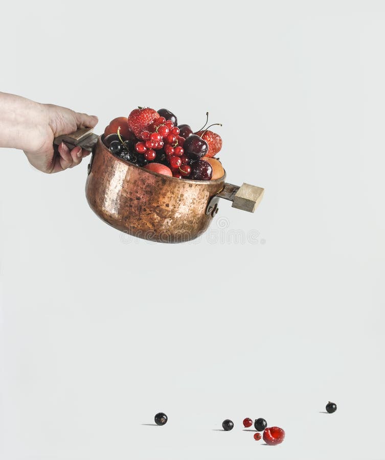 Women Hand Holding Cooking Pot with Various Berries on White Background ...