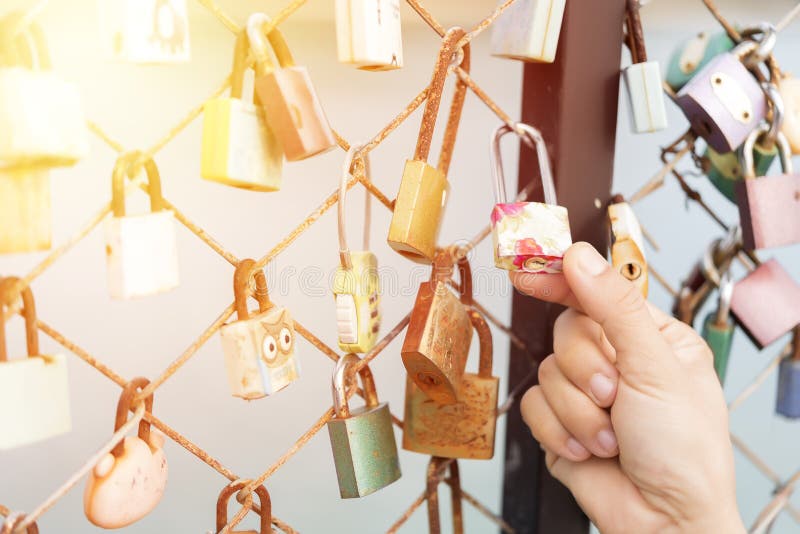 Women Hand Holding Master Key with Bridge Rail Locks of Love Stock ...
