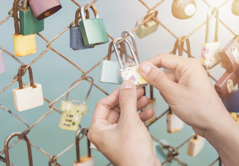 Women Hand Holding Master Key with Bridge Rail Locks of Love Stock ...