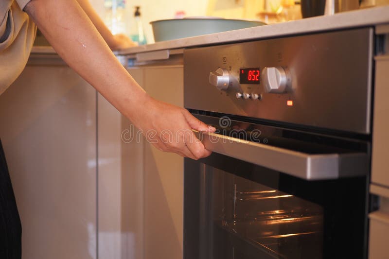Women Hand Open Electric Oven at Home Stock Photo - Image of opens ...