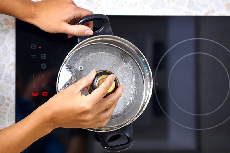 Women Hand Open a Saucepan in Modern Kitchen with Induction Stove Stock ...