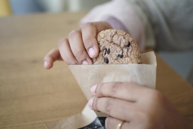 Women Hand Taking Cookies Out from a Paper Packet Stock Photo - Image ...