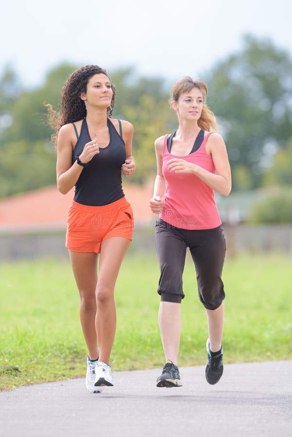Women jogging in park stock photo. Image of company, healthy - 82965740