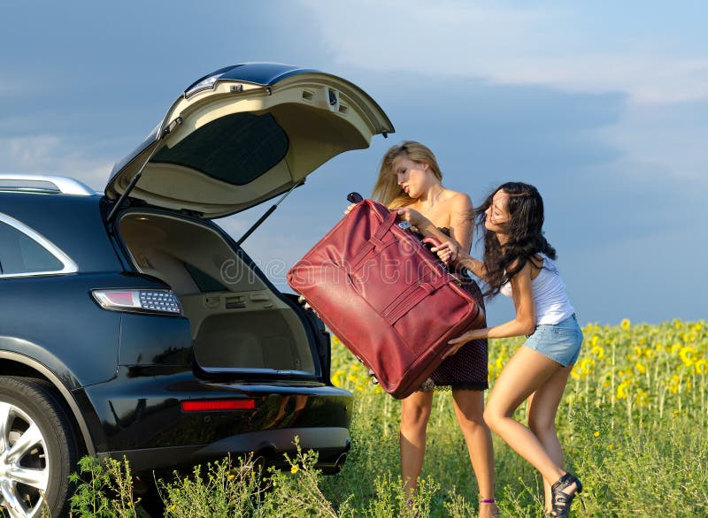 Women Loading a Heavy Bag into Car Stock Photo - Image of brunette ...