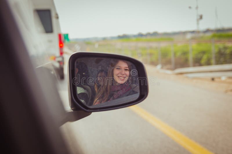 Women Looking at the Camera through the Car Side View Mirror Stock ...