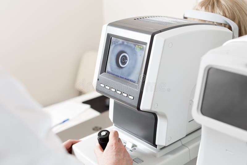Women Looking at Eye Test Machine in Ophthalmology Clinic Stock Photo ...