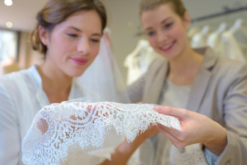 Women Looking at Lace Wedding Dress Stock Image - Image of women ...
