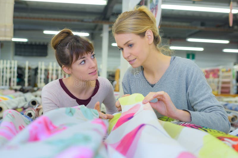 Women looking at textiles stock photo. Image of human - 233110276