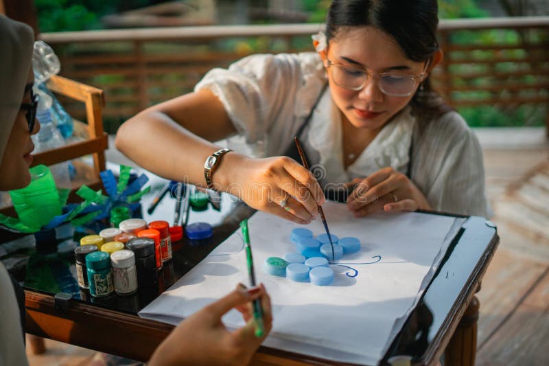 Women Making Art Using Plastic Bottle Cap Stock Photo - Image of apron ...