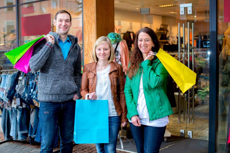 Women and a Man in Front of Clothes Shop Stock Photo - Image of apparel ...
