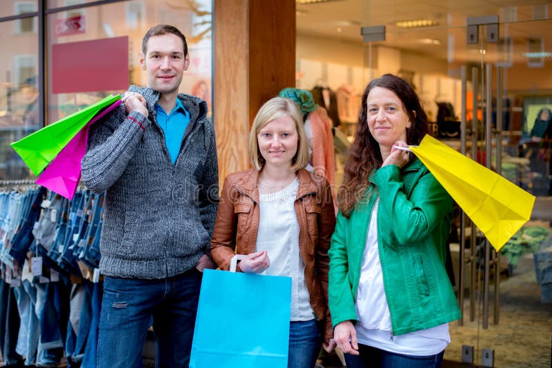 Women and a Man in Front of Clothes Shop Stock Photo - Image of ...