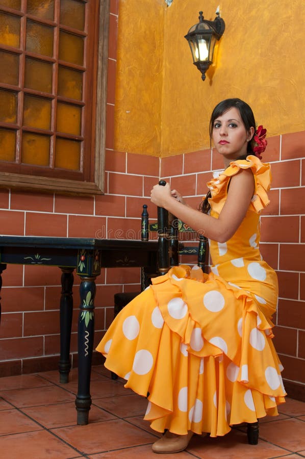 Women And Man In Traditional Flamenco Dresses Dance During The Feria De