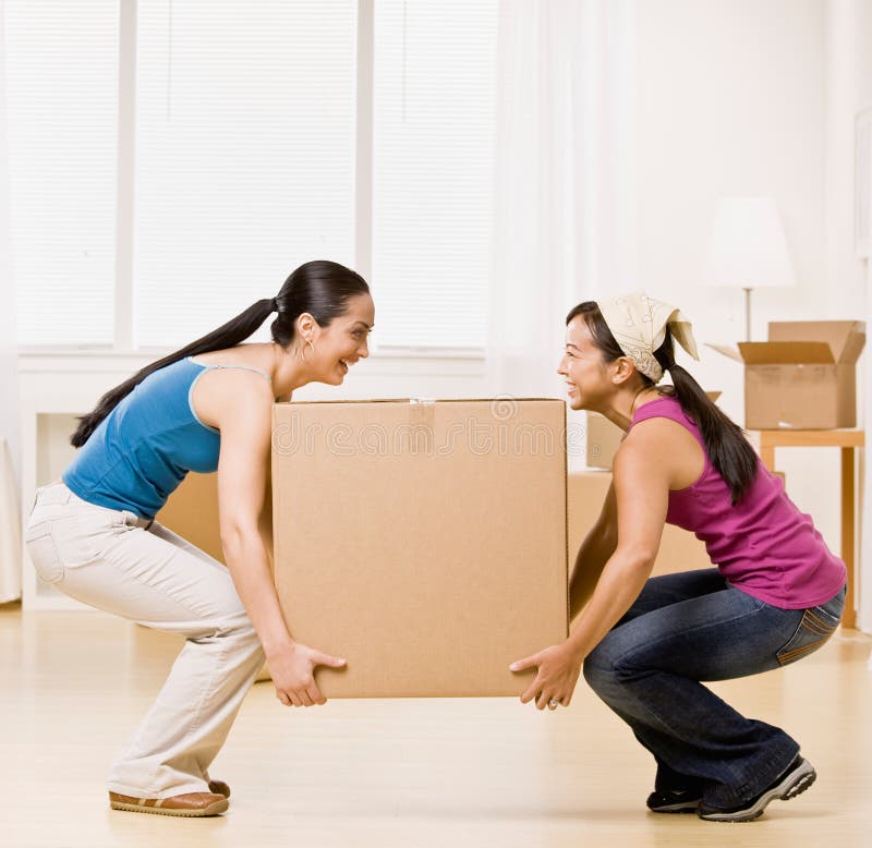 Women Moving into New Home and Carrying Box Stock Photo - Image of ...