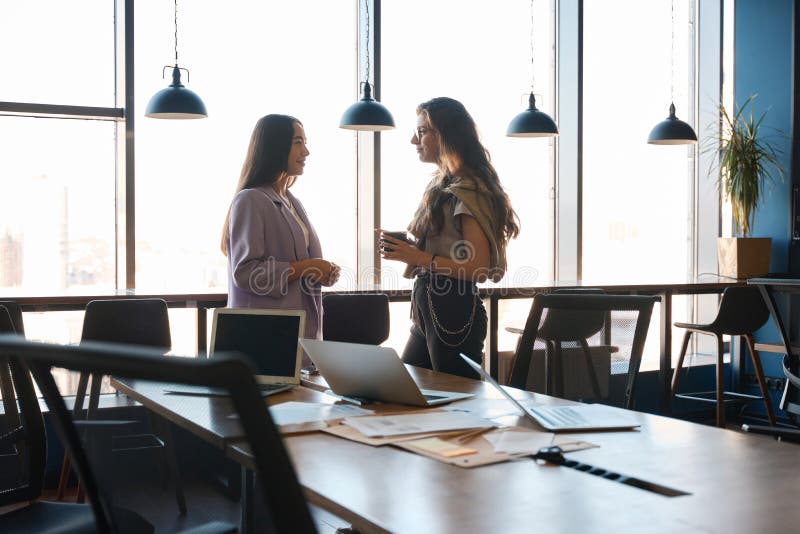 Women Office Workers Chatting at Ease at the Panoramic Window Stock ...