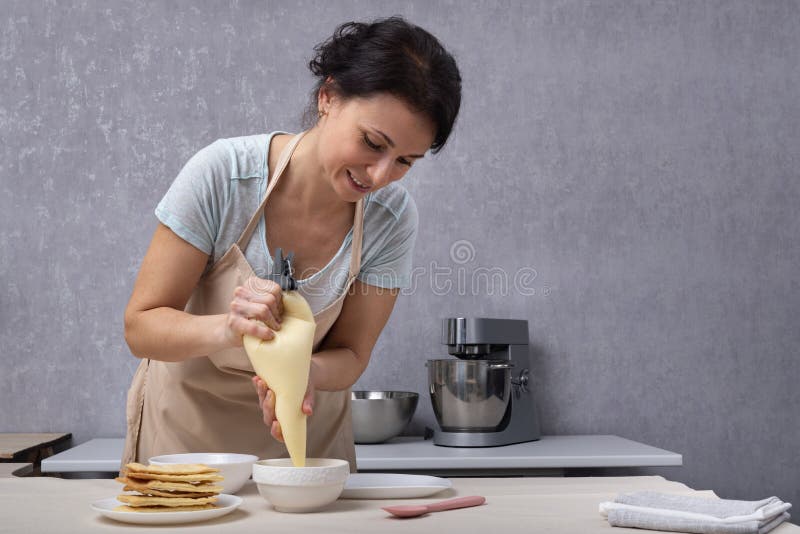 Women Pastry Chef Prepares Cake from Shortcakes and Cream. Process of ...