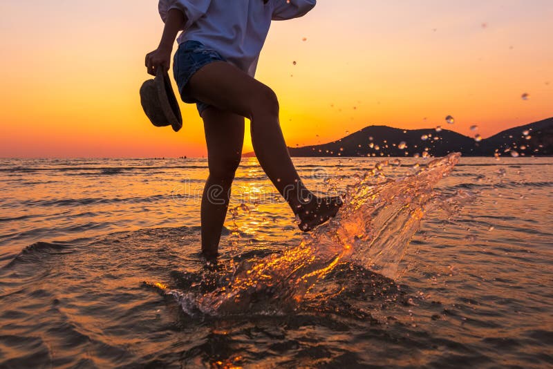 Women Play Water Splash on the Beach between Sunset Stock Photo - Image ...
