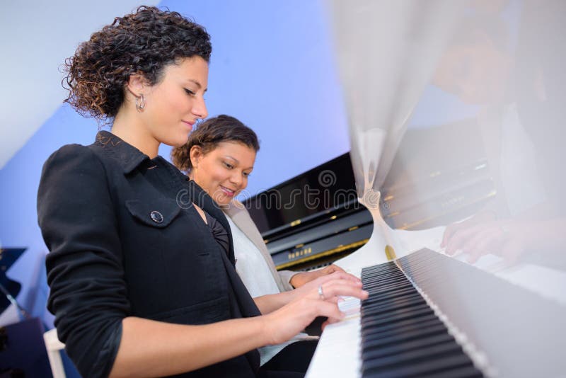Women Playing Duet on Piano Stock Image - Image of adult, sibling ...