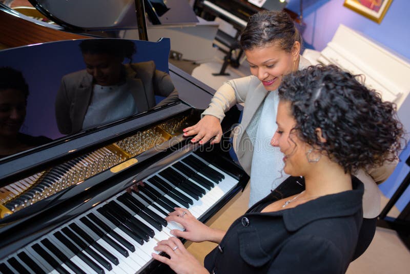 Women playing piano stock photo. Image of rehearsal - 208759162