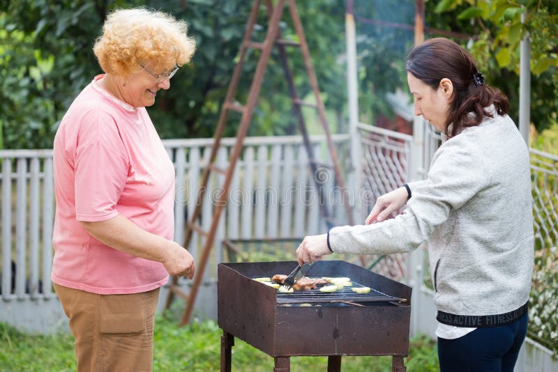 Women Preparing the Barbecue Outside Stock Photo - Image of grilling ...