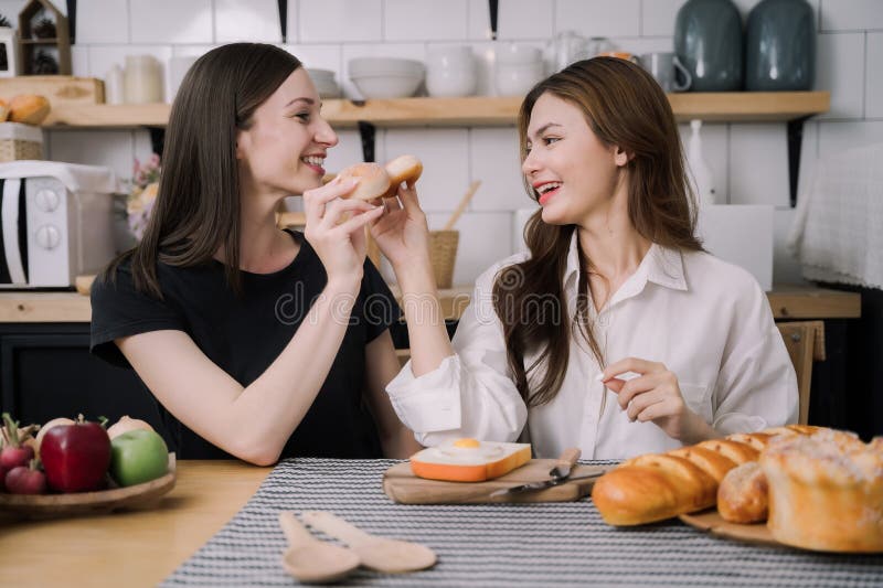 Women Preparing Food Playing with Vegetables and Bread in Kitchen ...