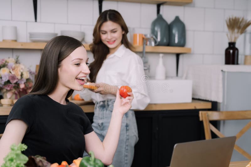 Women Preparing Food Playing with Vegetables and Bread in Kitchen ...