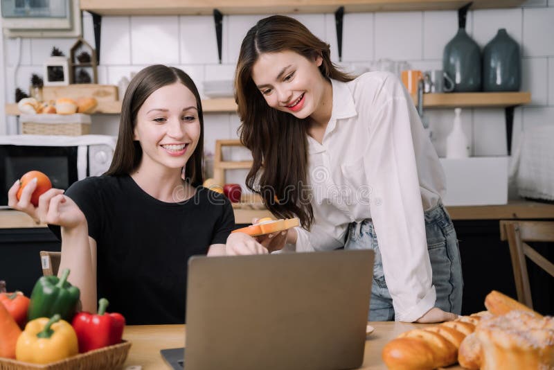 Women Preparing Food Playing with Vegetables and Bread in Kitchen ...