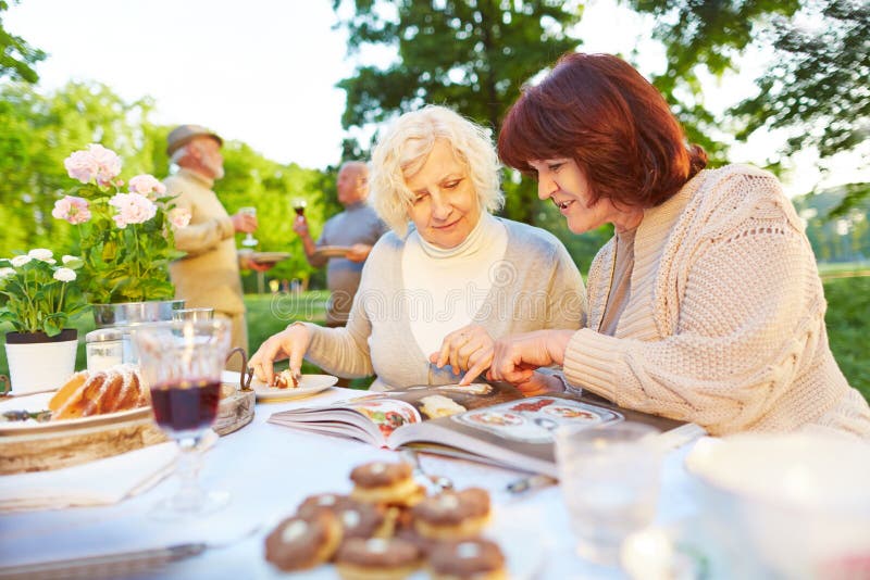 Women Reading Cookbook while Eating Cake Stock Photo - Image of ...
