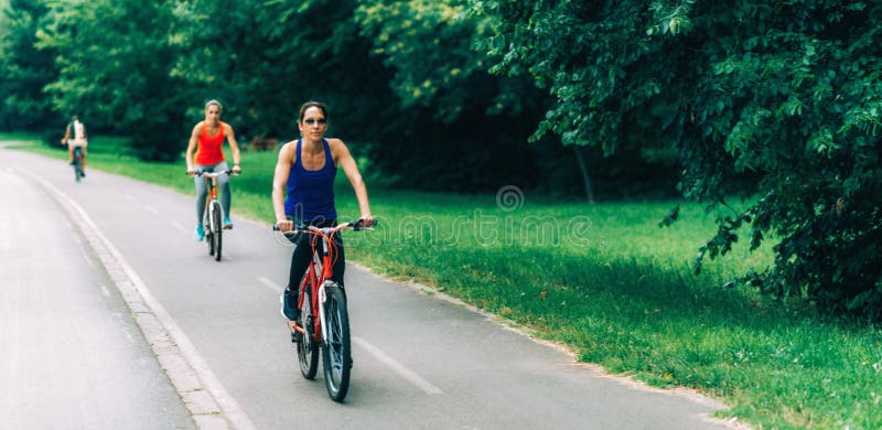 Women Riding Bicycles Together Stock Image - Image of outdoors, leisure ...