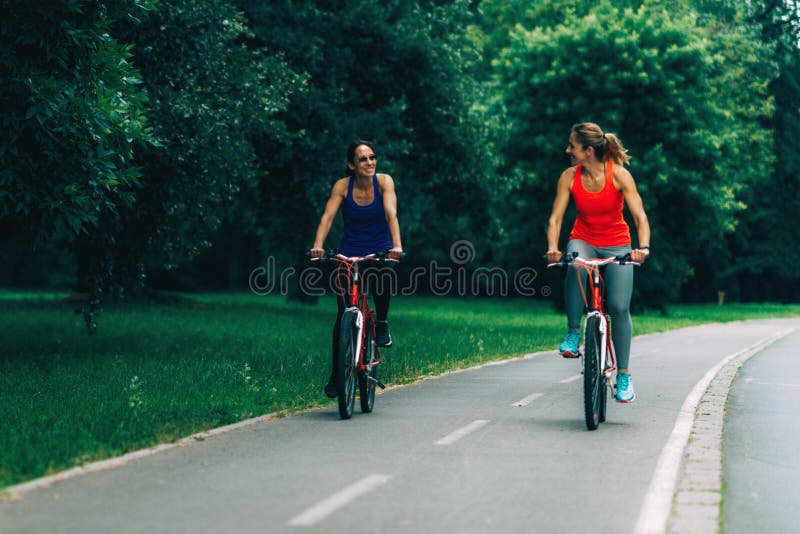 Women Riding Bicycles Together Stock Photo - Image of cycle, biking ...