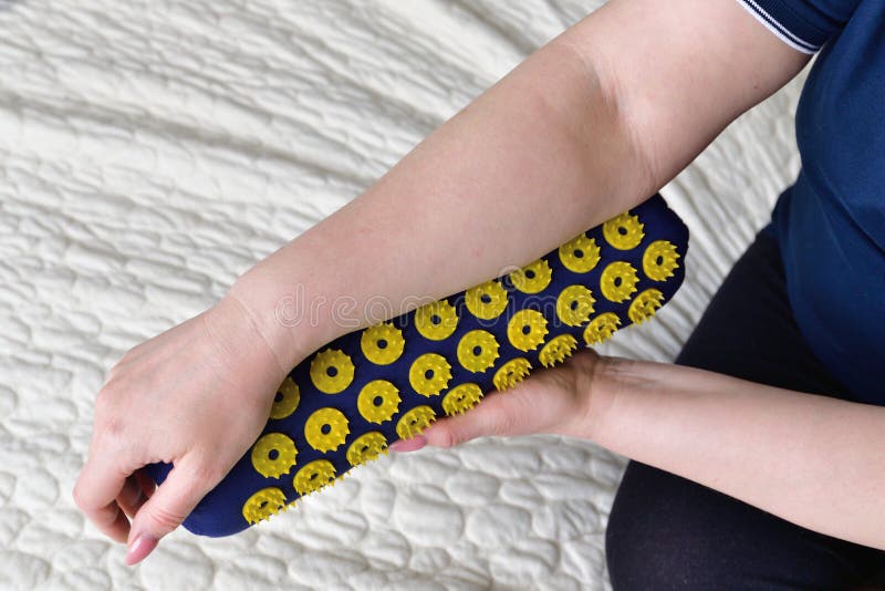 Women& X27;s Forearm on a Needle Roller - Foot Massage Using an ...