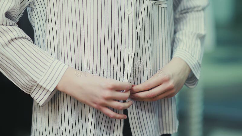Women& X27;s Hands are Buttoning Up the Buttons on a Striped Blouse ...