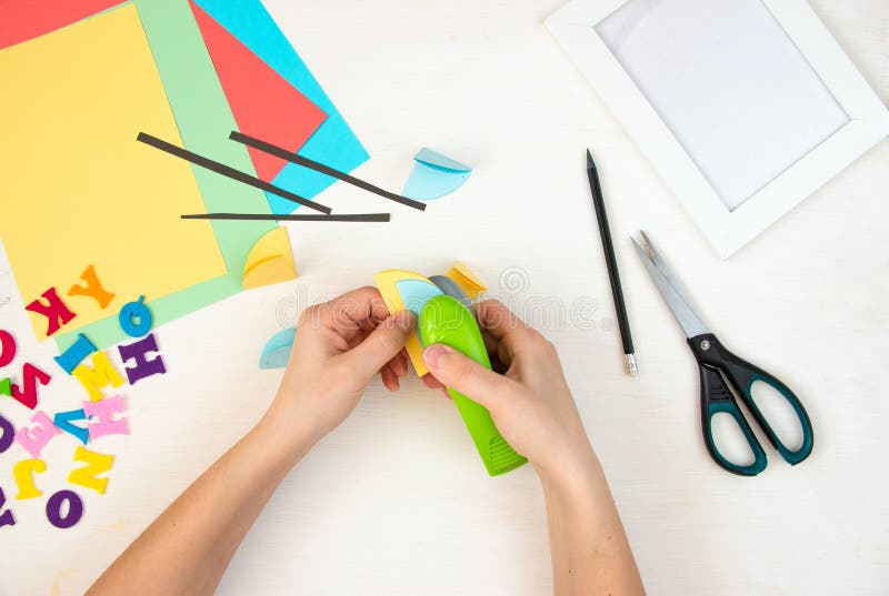 Women`s Hands are Stapling Paper Circles with a Stapler. Step by Step ...