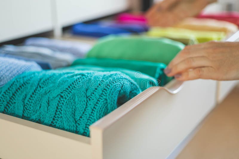 Women S Hands Take Bright Rainbow Clothes from a Wardrobe Drawer. the ...