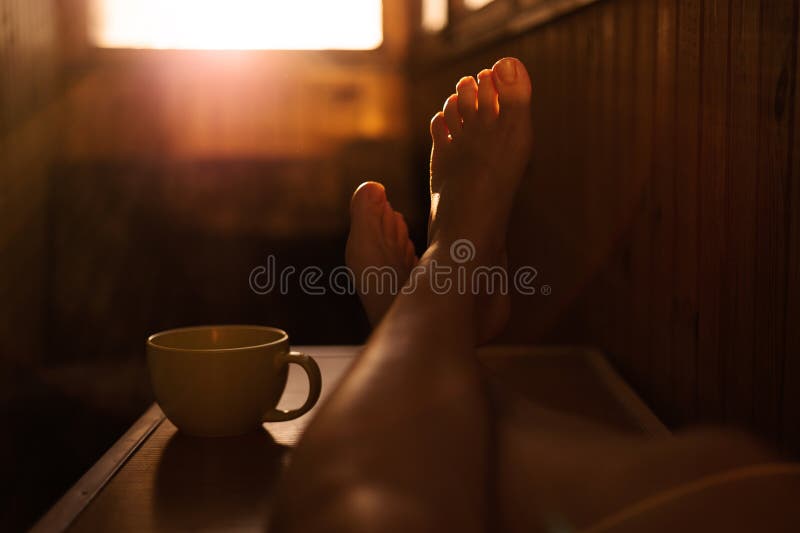 Legs and a Cup of Tea at Sunset Stock Photo - Image of interior ...